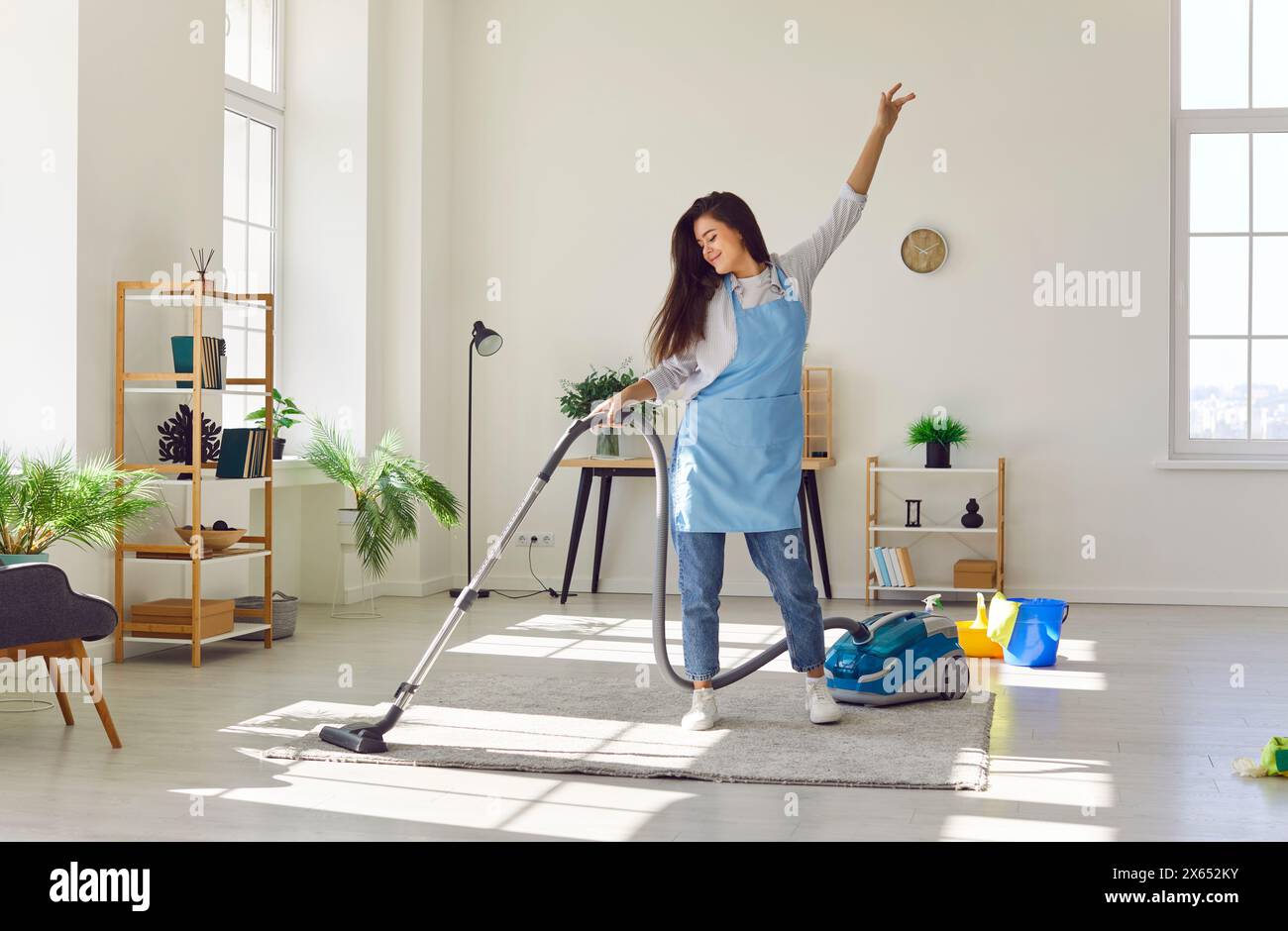 Positive young woman vacuum hi-res stock photography and images - Alamy