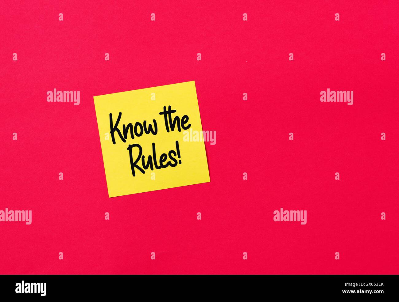 Know the rules message on a yellow sticky note paper on red background ...