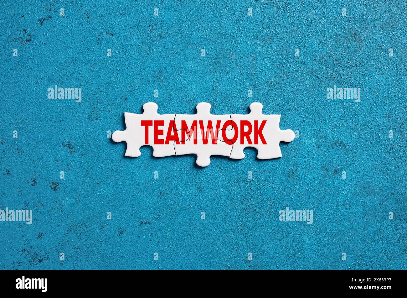The word teamwork written on puzzle pieces on blue background. Teamwork ...