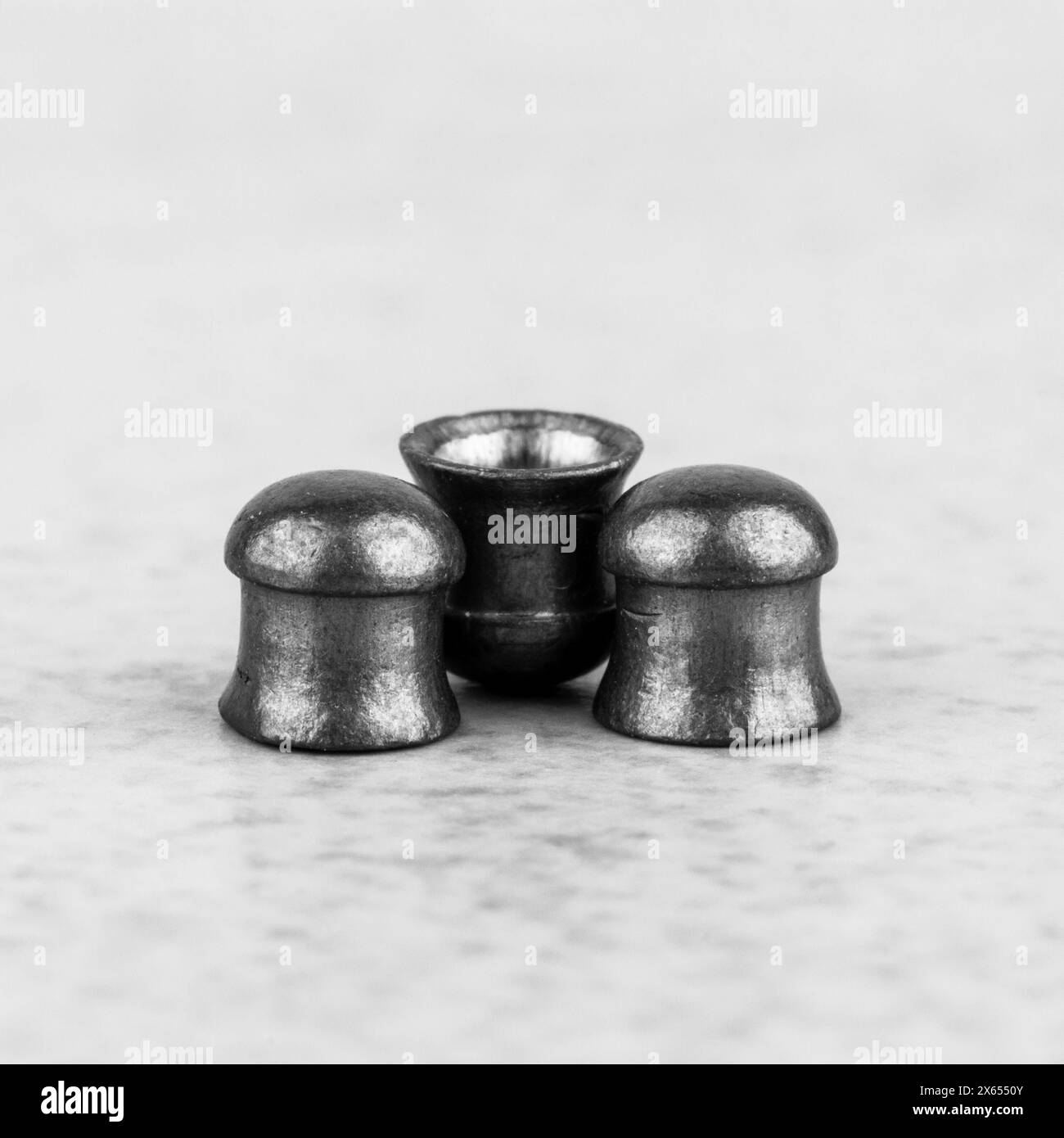 lead bullets for pneumatic weapons on a gray background closeup, black ...
