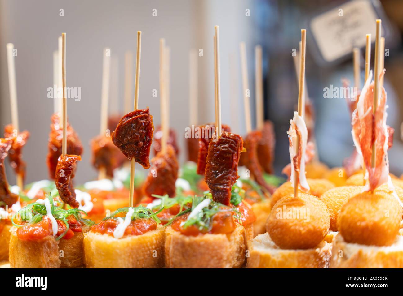 Basque pinchos (form of Spanish tapas), with bread and Spanish ham, in ...