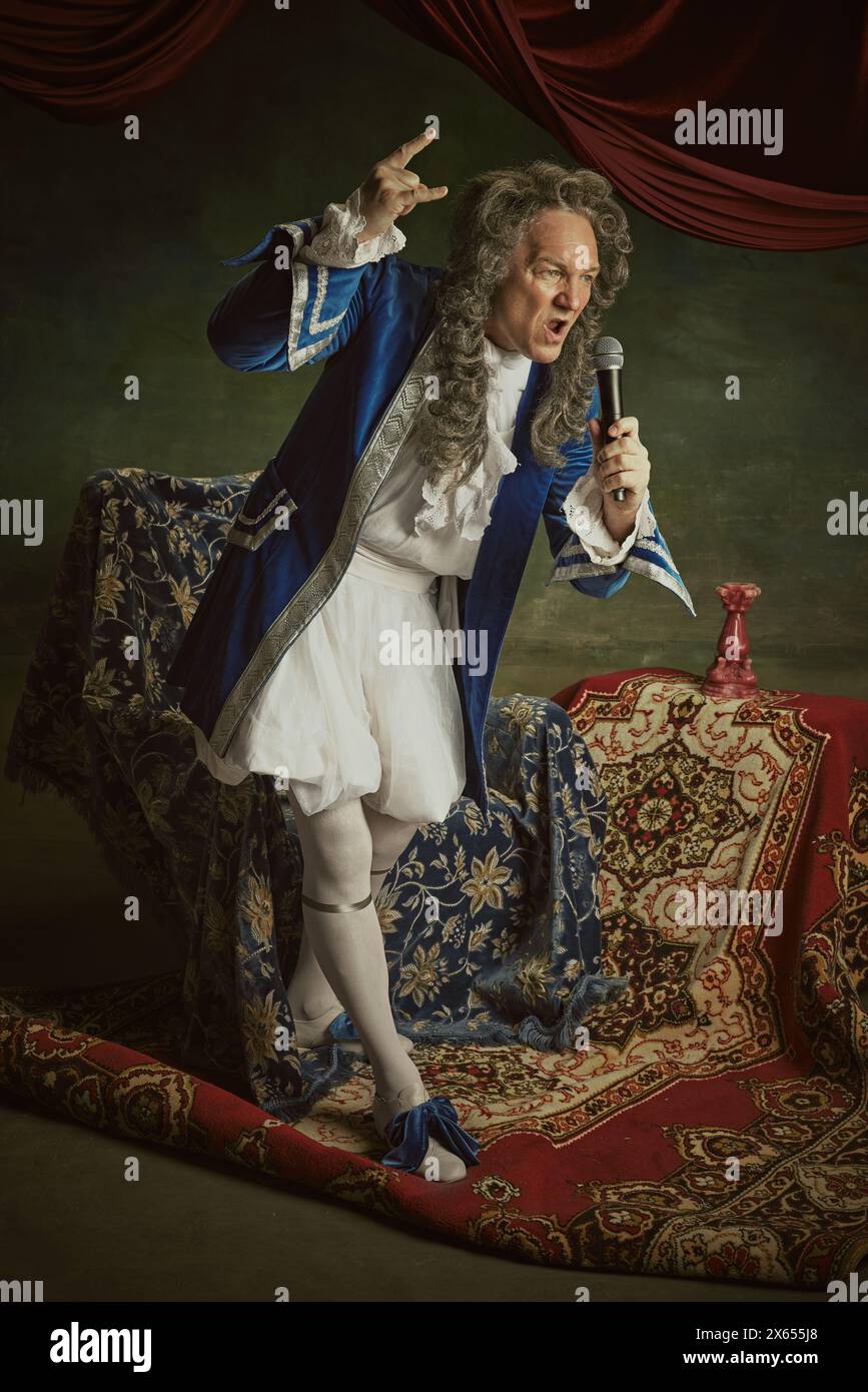 Man dressed historical baroque-style attire, looks as lord, singing to ...