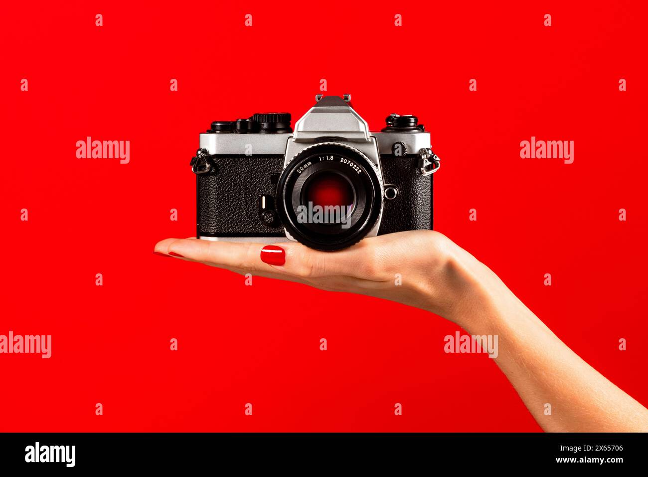 Crop anonymous woman demonstrating professional retro film camera ...