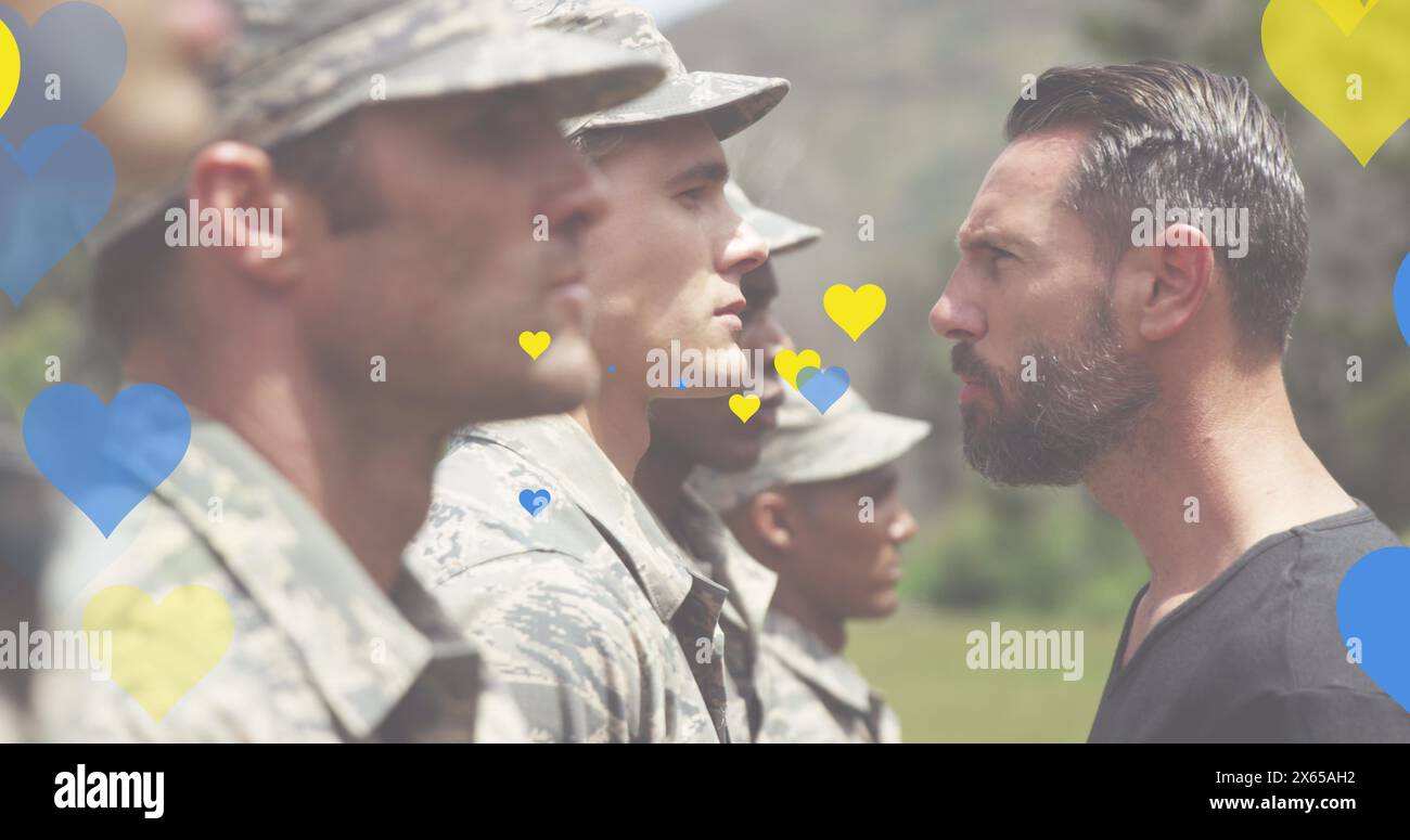 Image of yellow and blue hearts floating over diverse male soldiers and ...