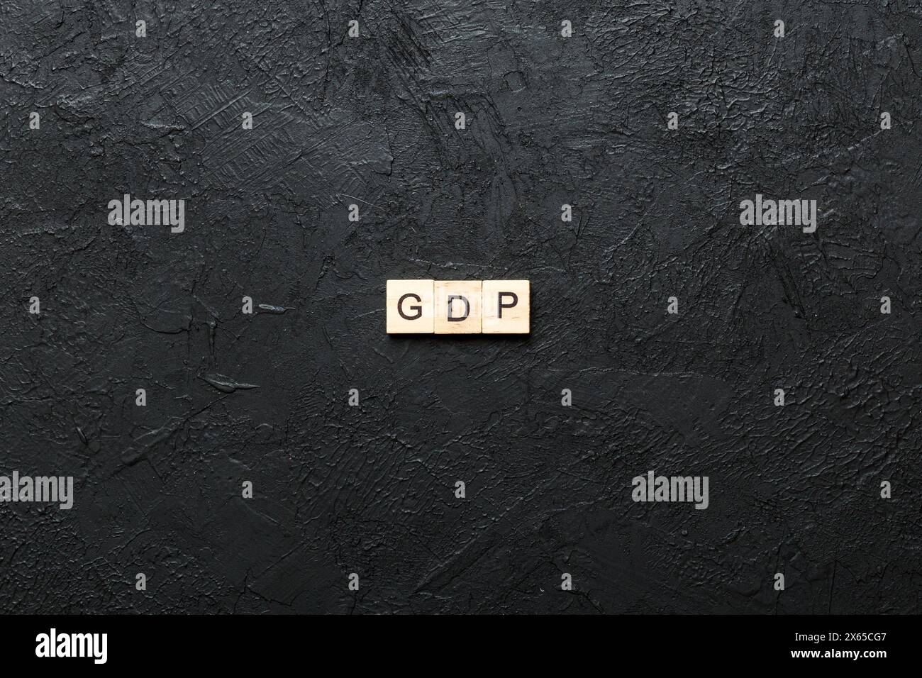 GDP word written on wood block. gross domestic product text on cement ...