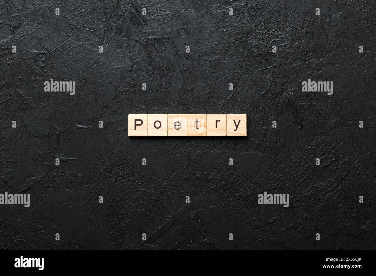 Poetry word written on wood block. Poetry text on cement table for your ...