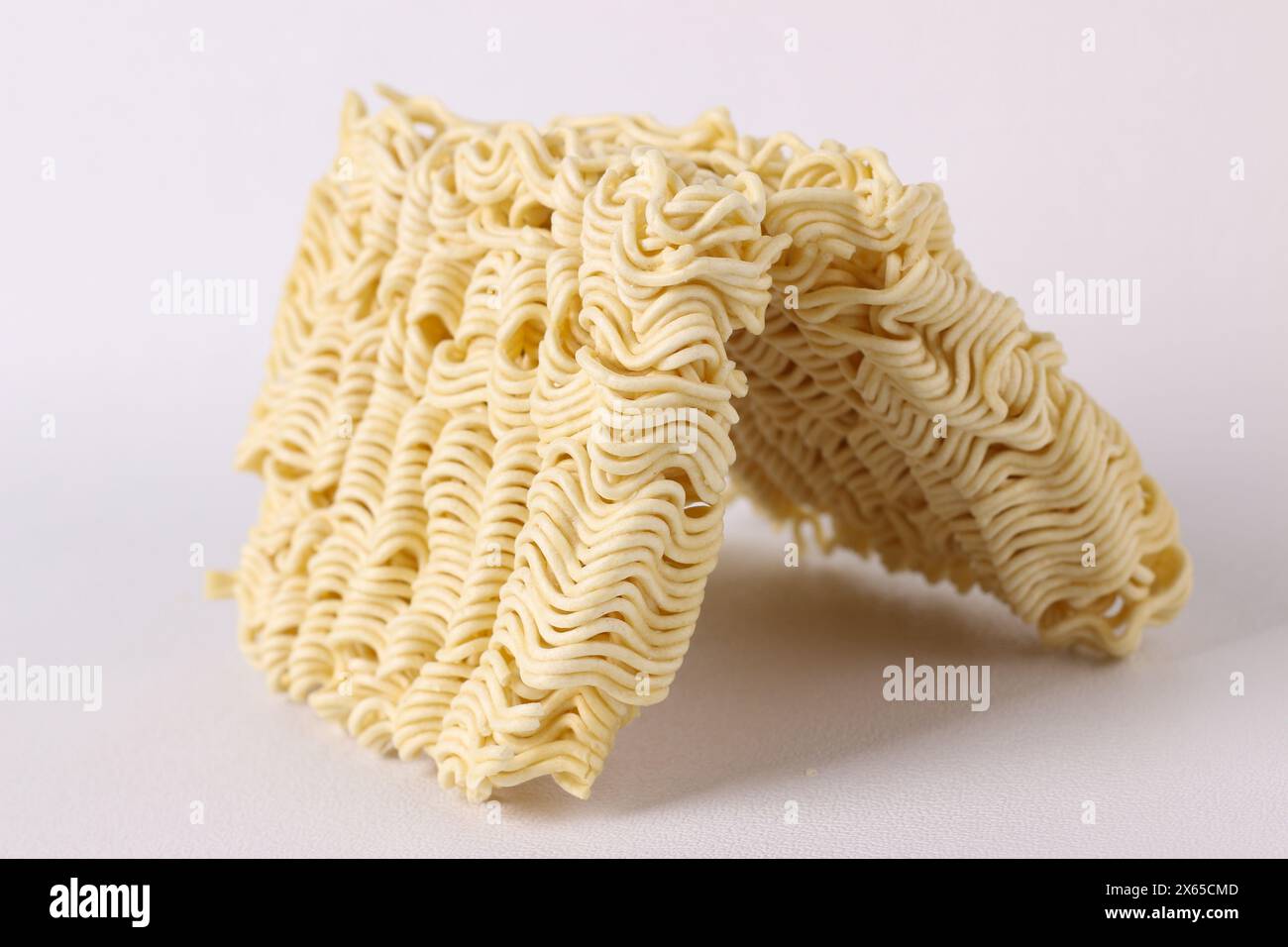 Dry uncooked instant noodles ramen with white background. Unhealthy ...