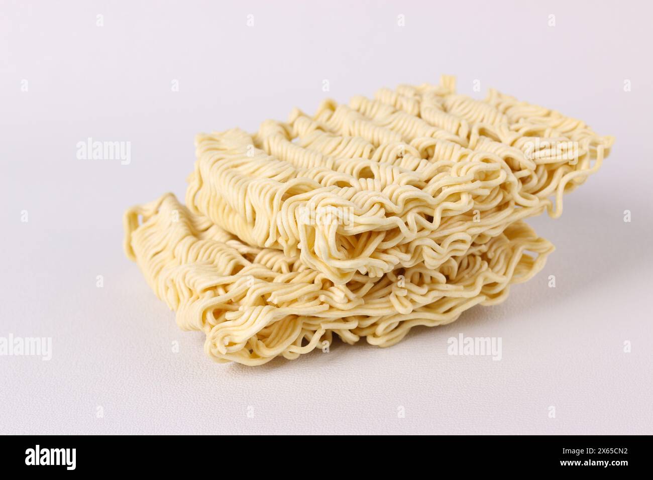 Dry uncooked instant noodles ramen with white background. Unhealthy ...