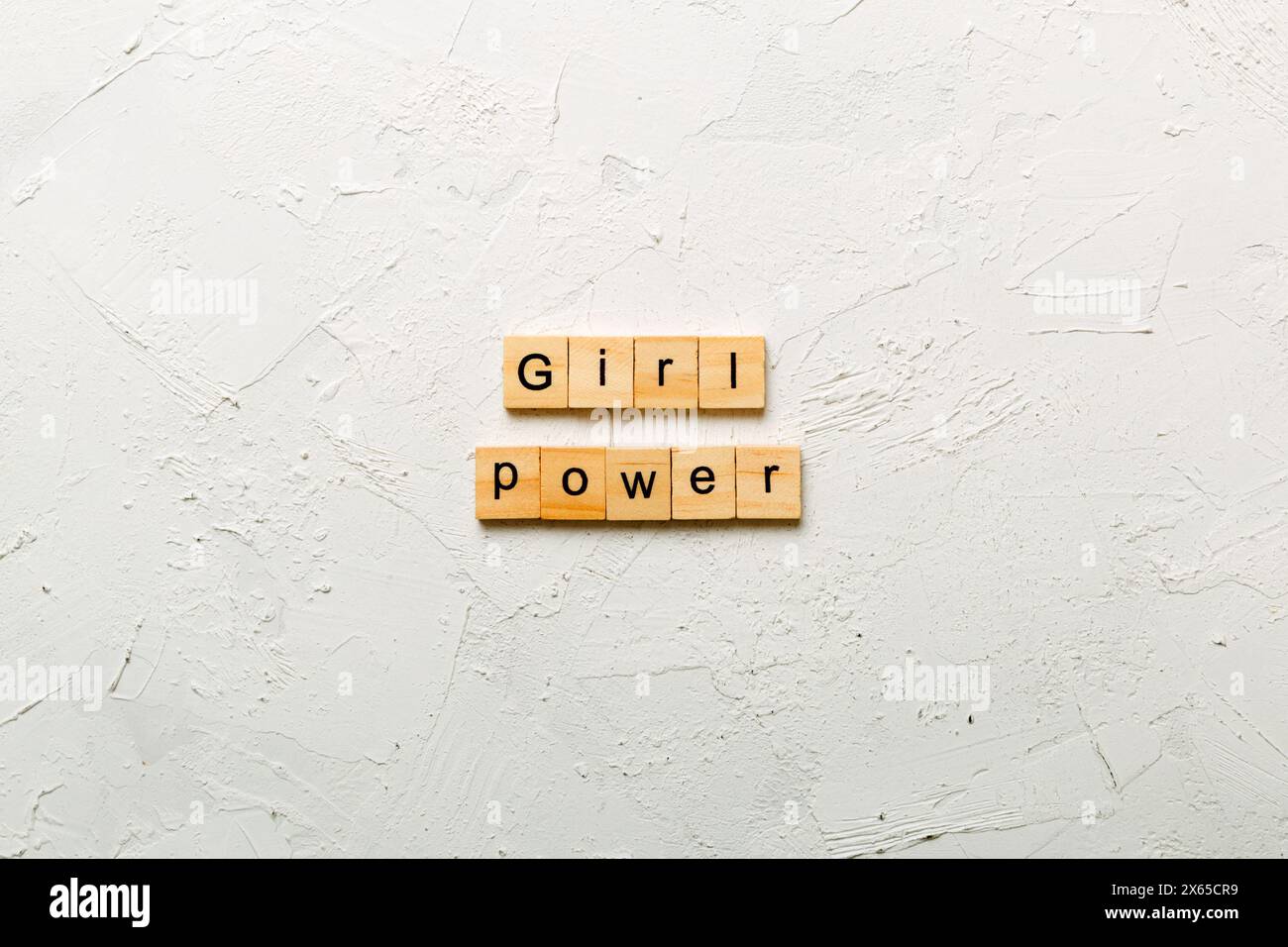 Girl Power word written on wood block. Girl Power text on cement table ...