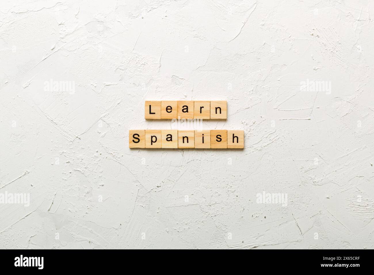 learn spanish word written on wood block. learn spanish text on table ...