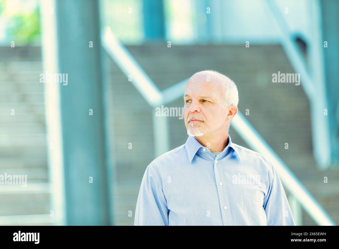 Business professional in front of a glass building shows a composed ...