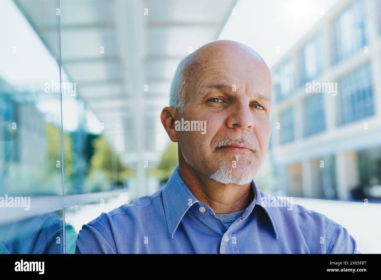 Seasoned businessman poses outdoors, light blue shirt complementing the ...