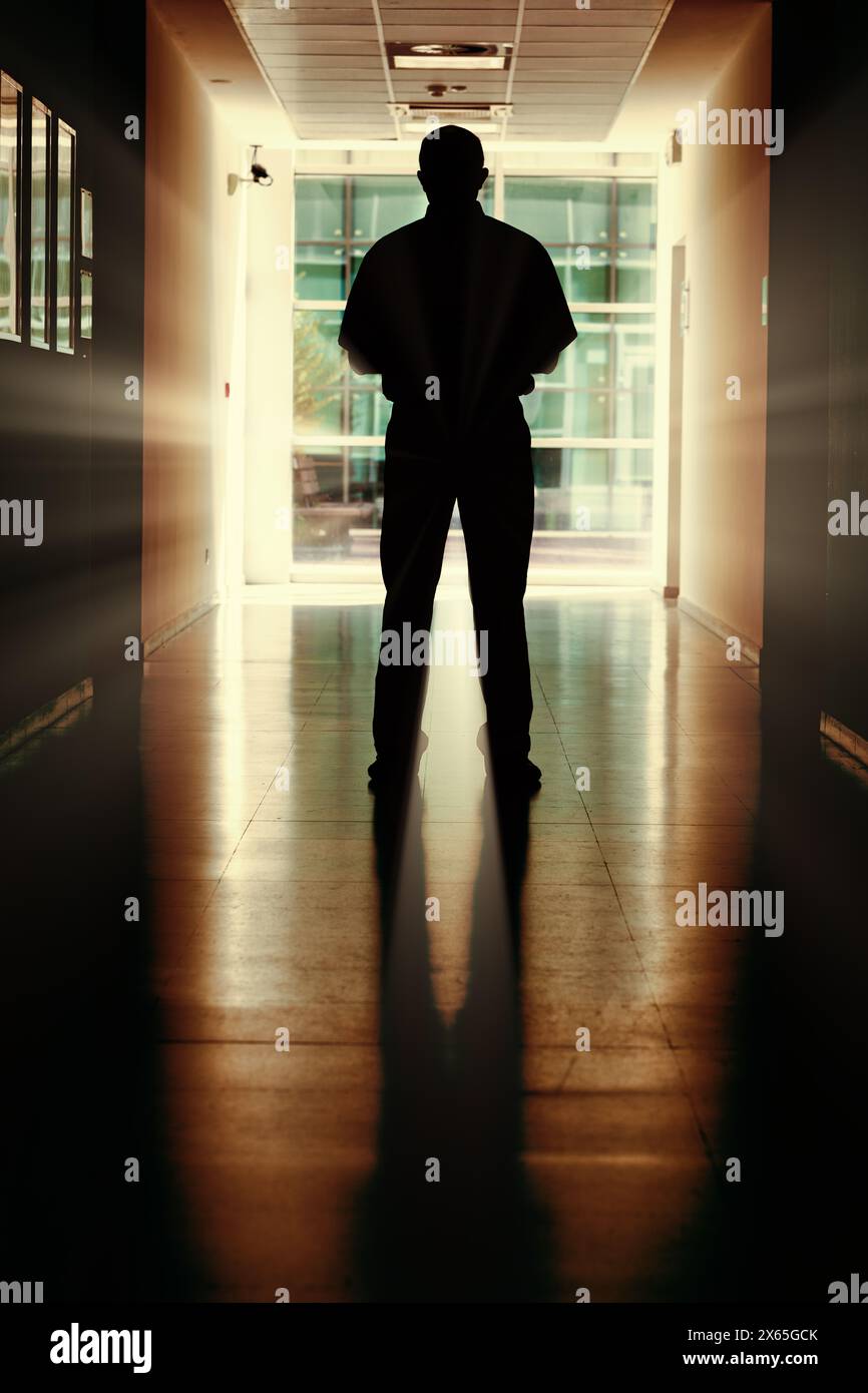 Mysterious figure in an office hallway, symbolizing life's passage and ...
