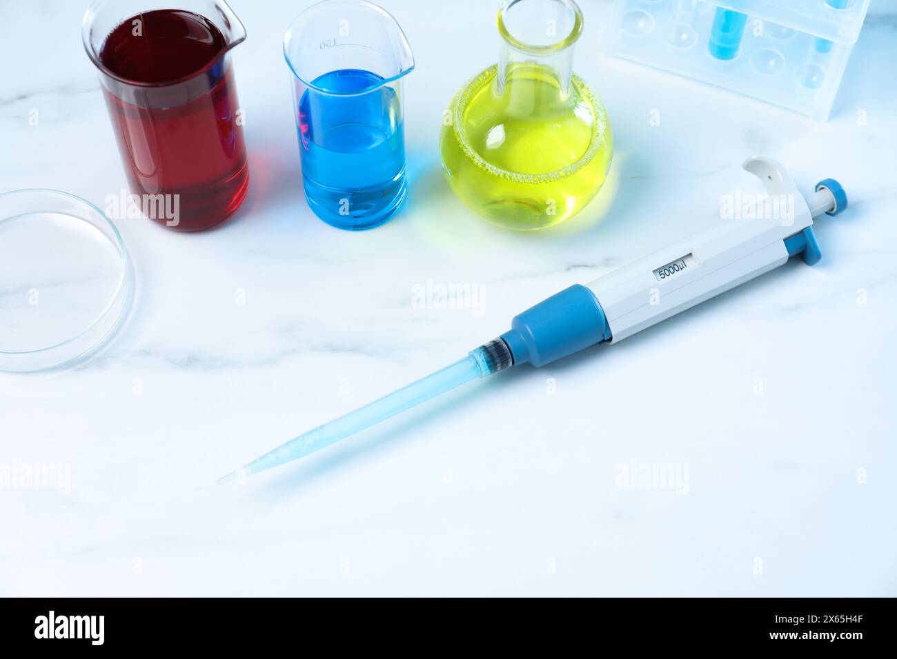 Laboratory analysis. Micropipette, petri dish and other glassware on ...