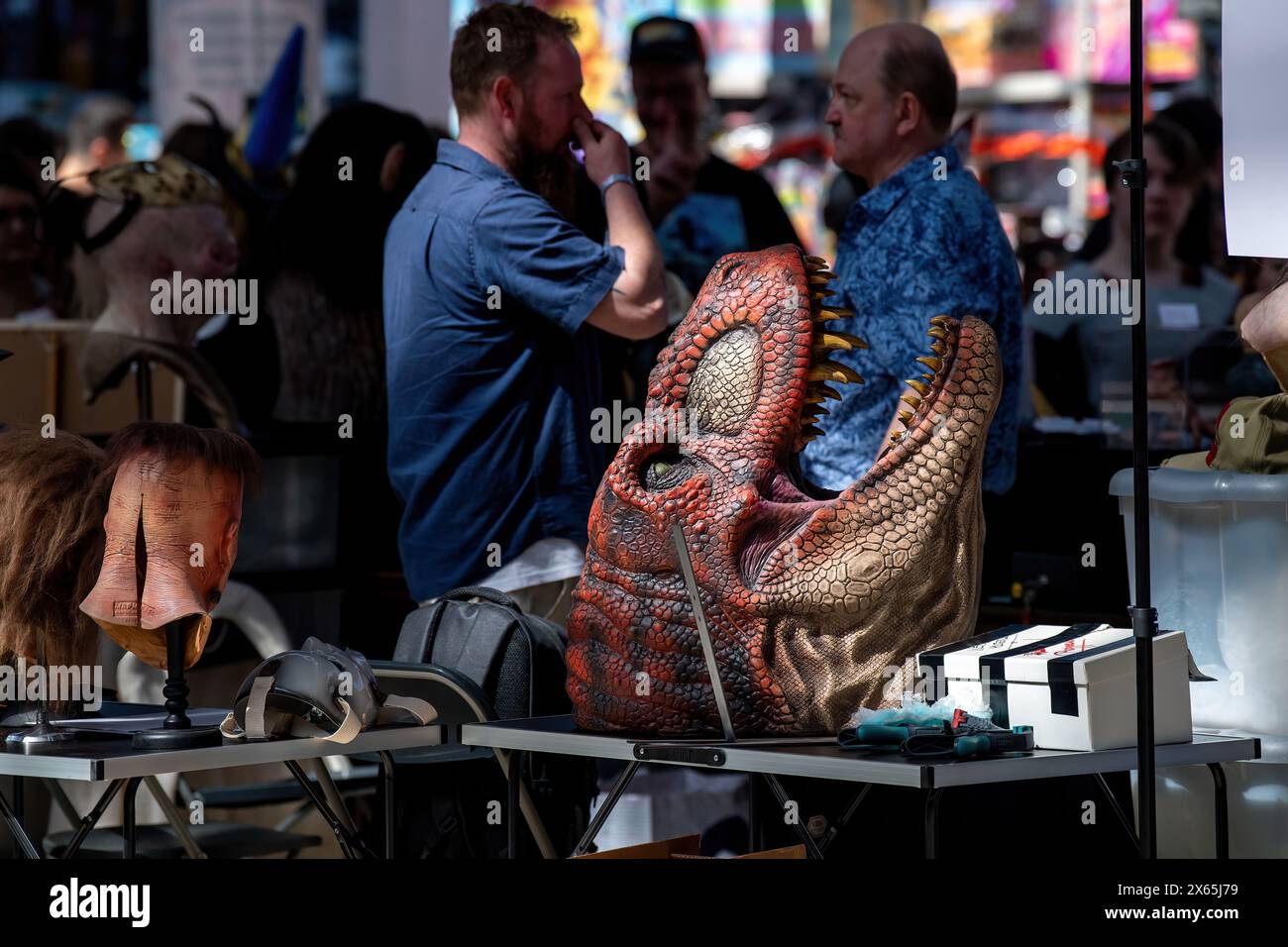 A dinosaur head mask in a store at Comic Con Brussels 2024. Cosplay enthusiasts and fans of ...