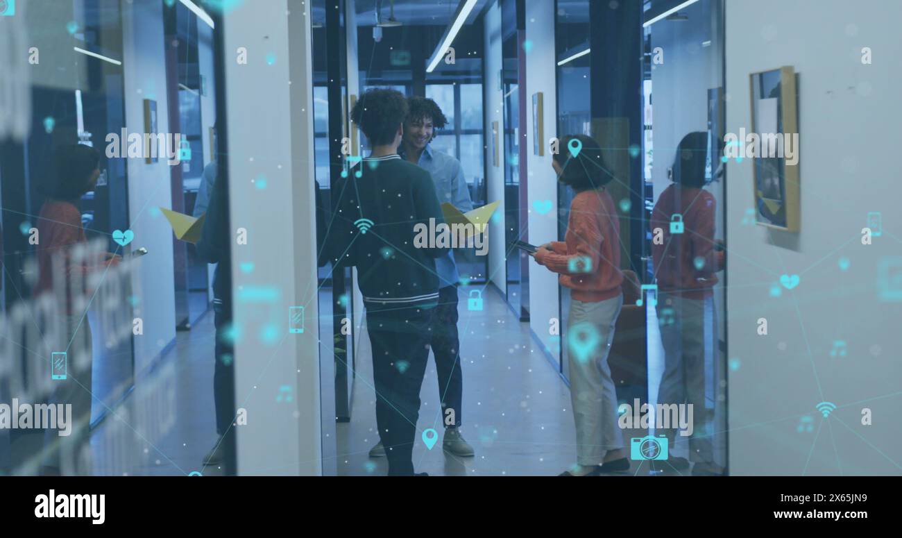 Image of network of digital icons against diverse colleagues discussing ...