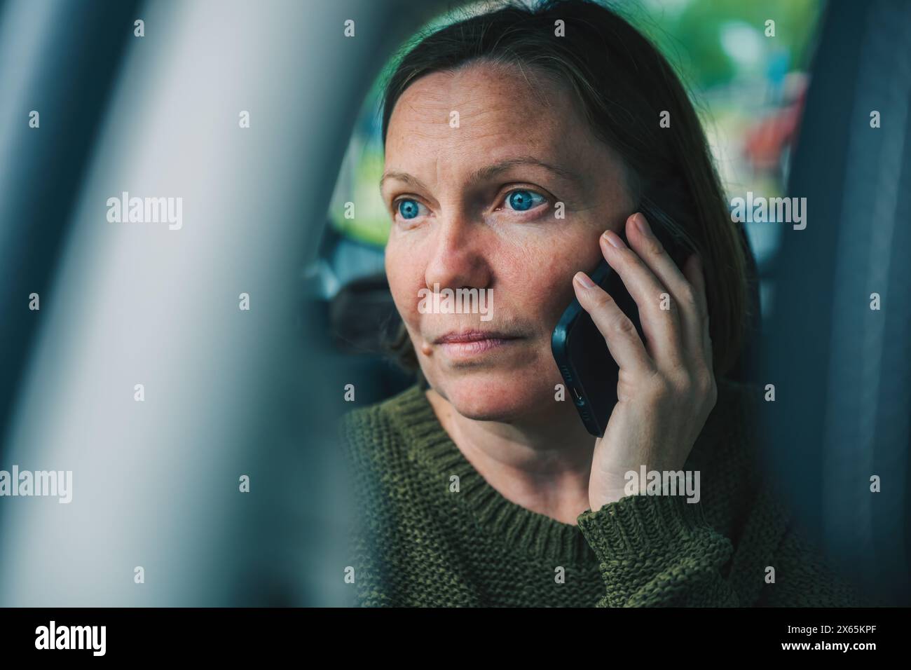 Portrait of serious disappointed mature adult female during phone call ...