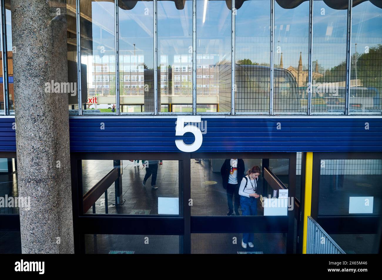 Passengers awaiting to board bus at gate five of Preston bus station ...