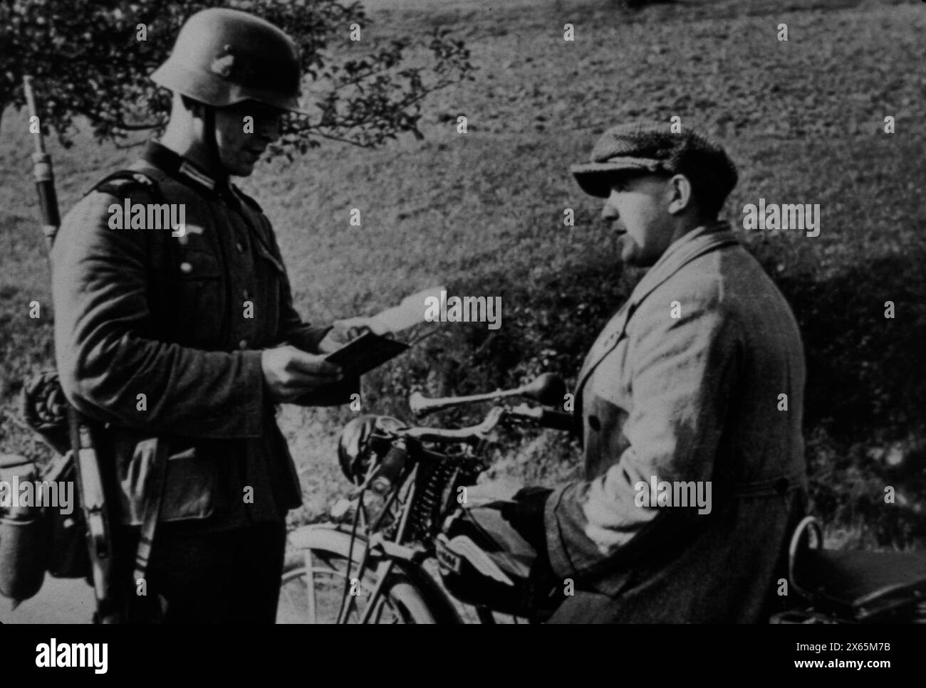 German soldier checking the papers of a Czech motorcyclist, Sudeten ...