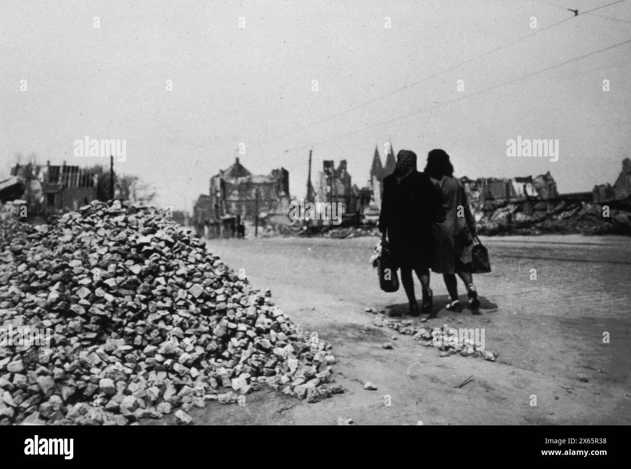 Two German women walk in the ruins of the city of Essen after the ...