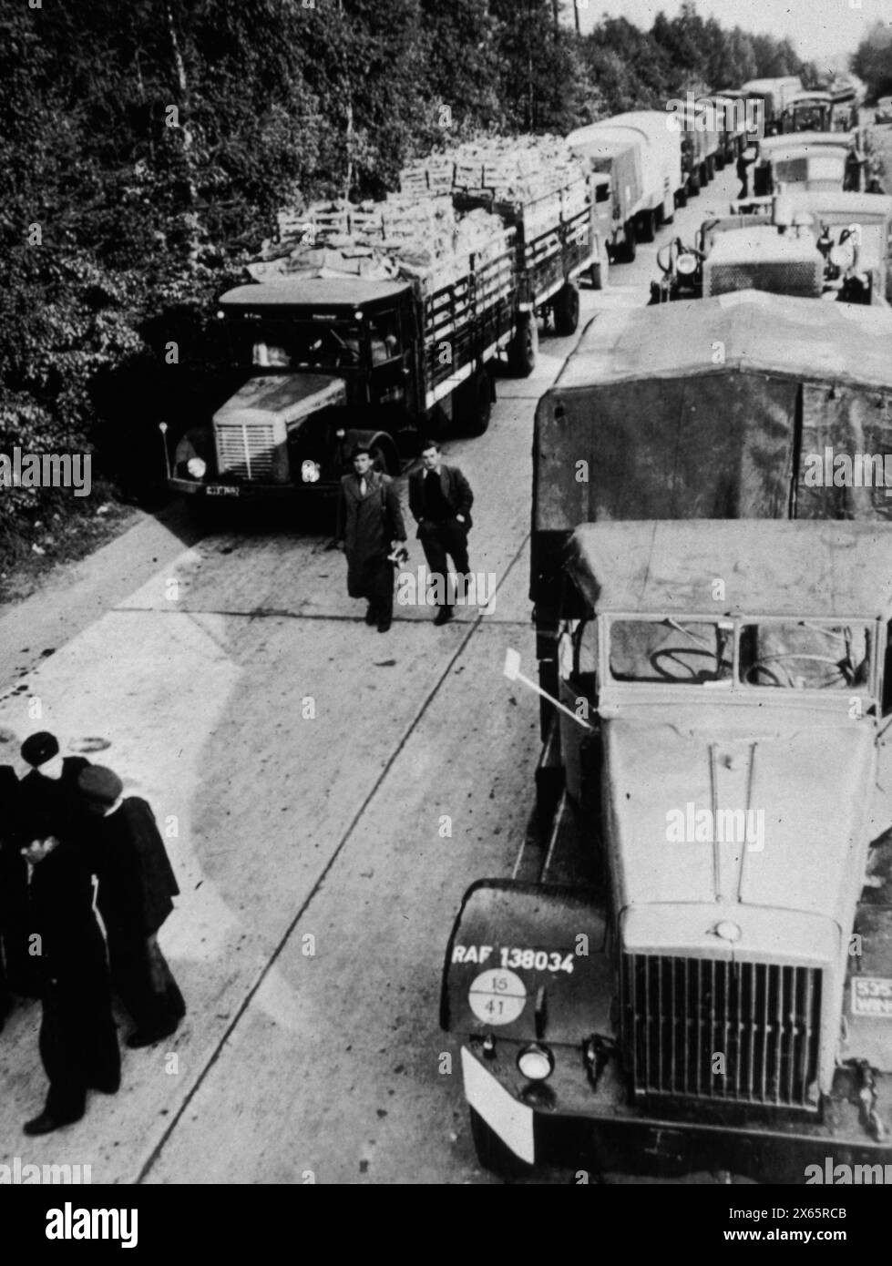 Trucks carrying vegetables are stopped by the Soviet blockade around ...