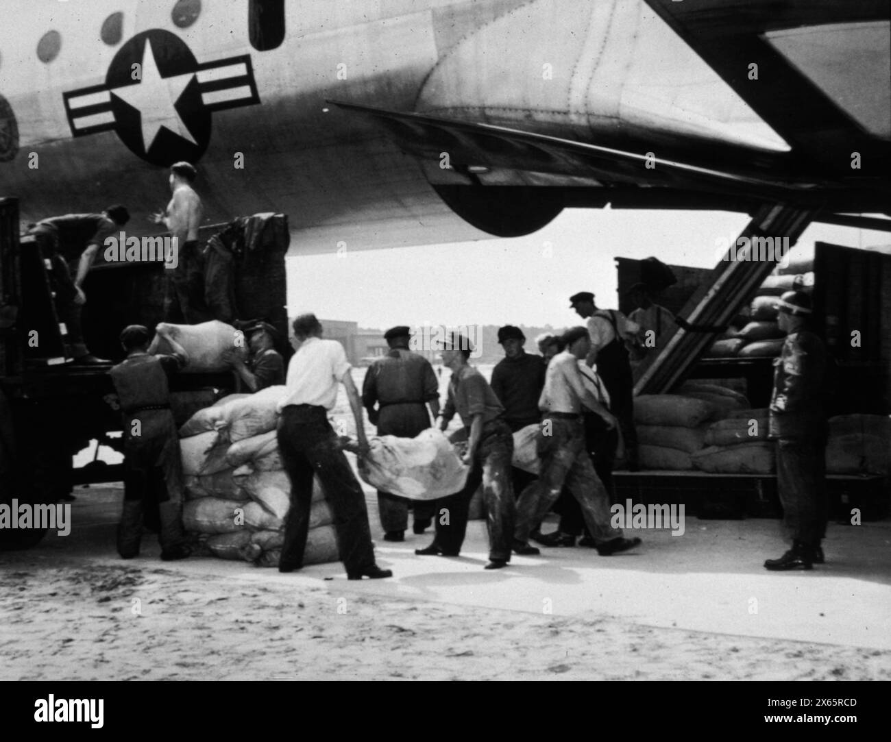 Unloading flour during the Berlin airlift to avoid the Soviet blockade ...