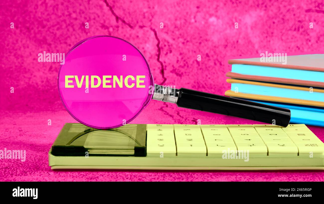 Word Evidence written through a magnifying glass on a calculator on a ...