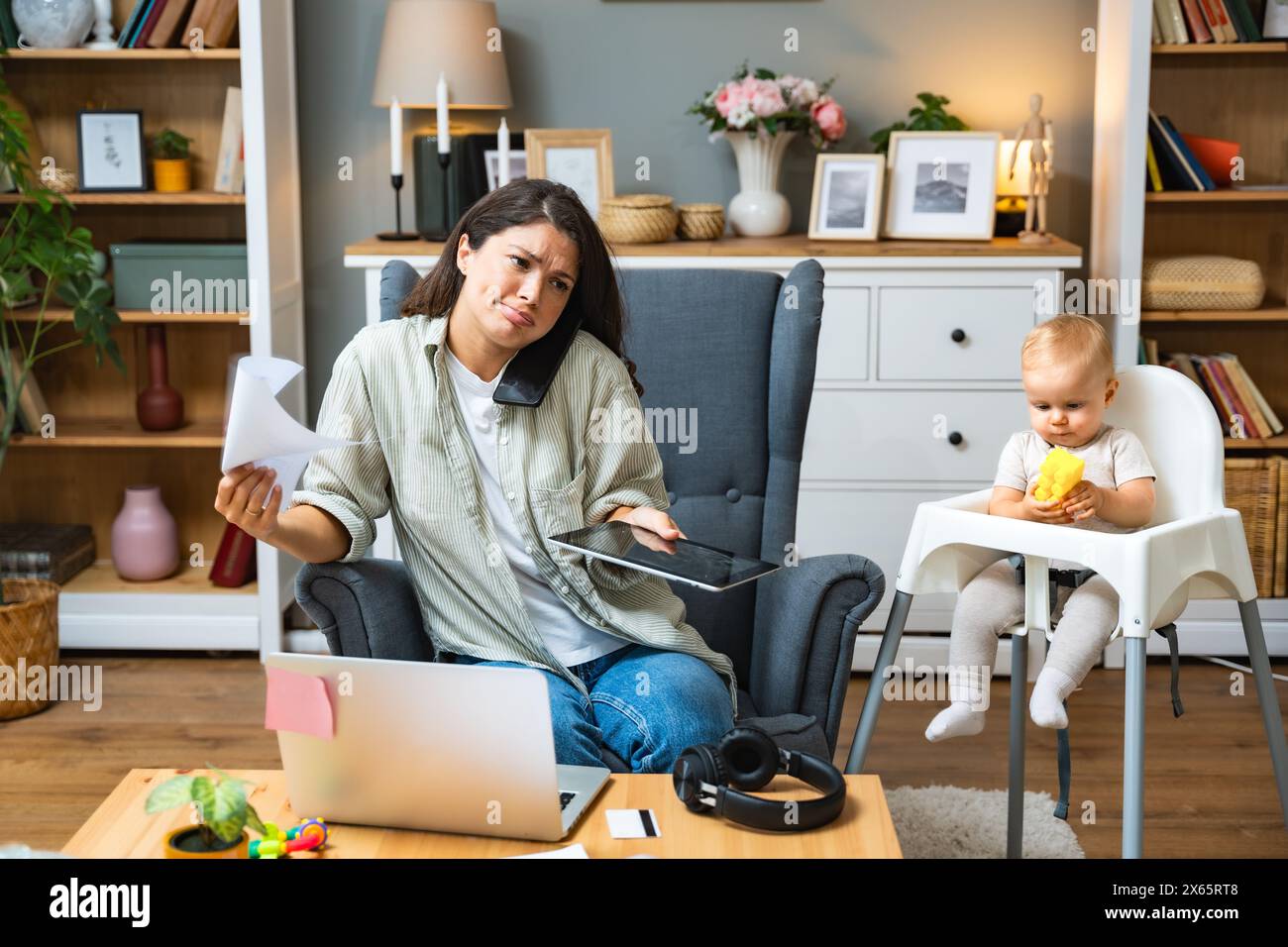 Multitasking mother. Young freelance business mom taking care of her ...
