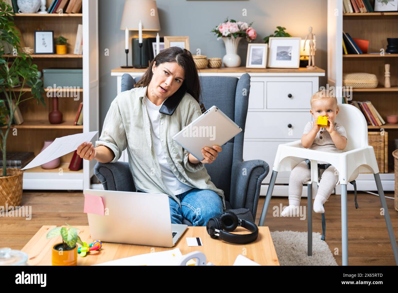 Multitasking mother. Young freelance business mom taking care of her ...