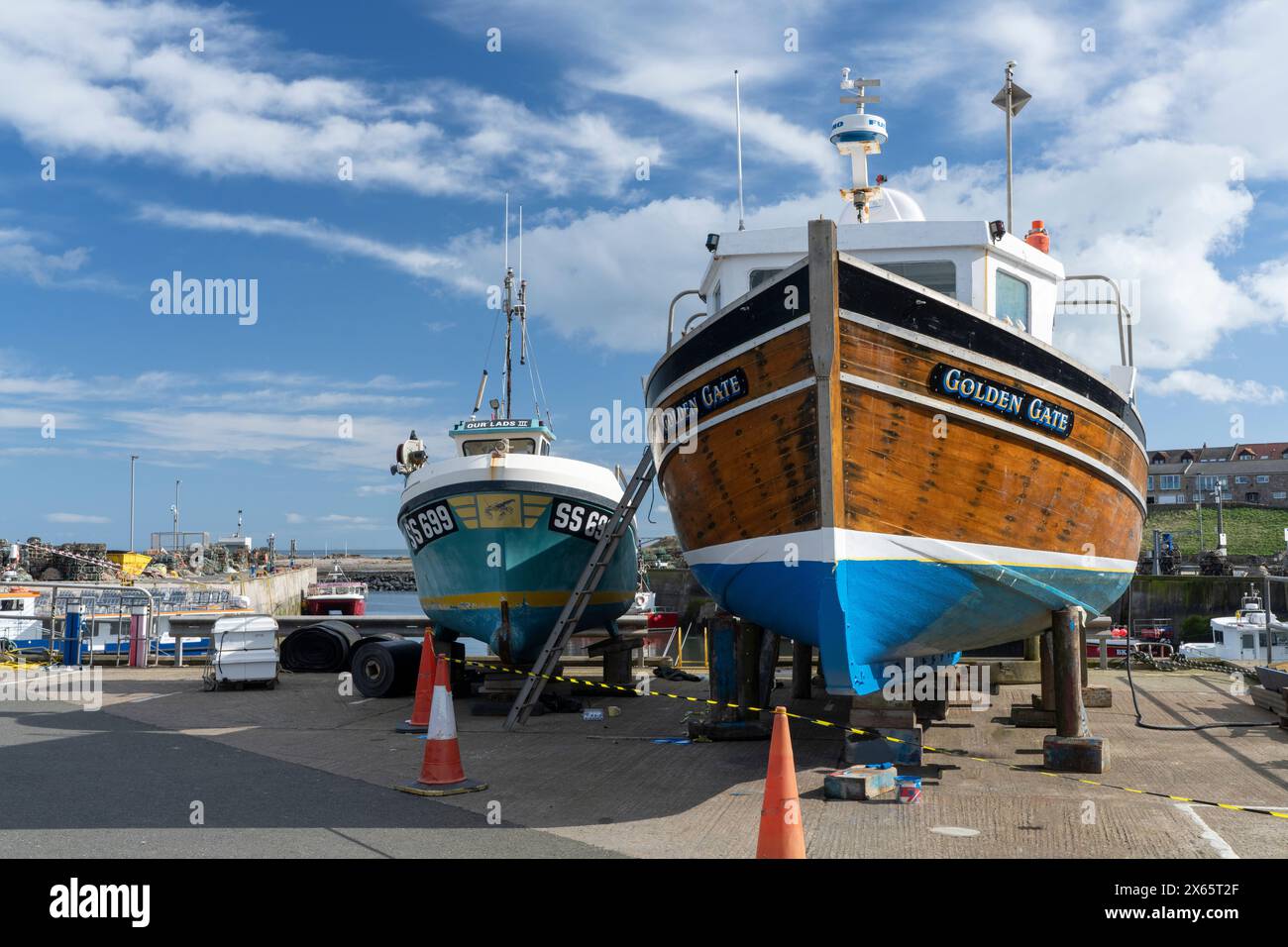 Boats on the harbour side being renovated Stock Photo - Alamy
