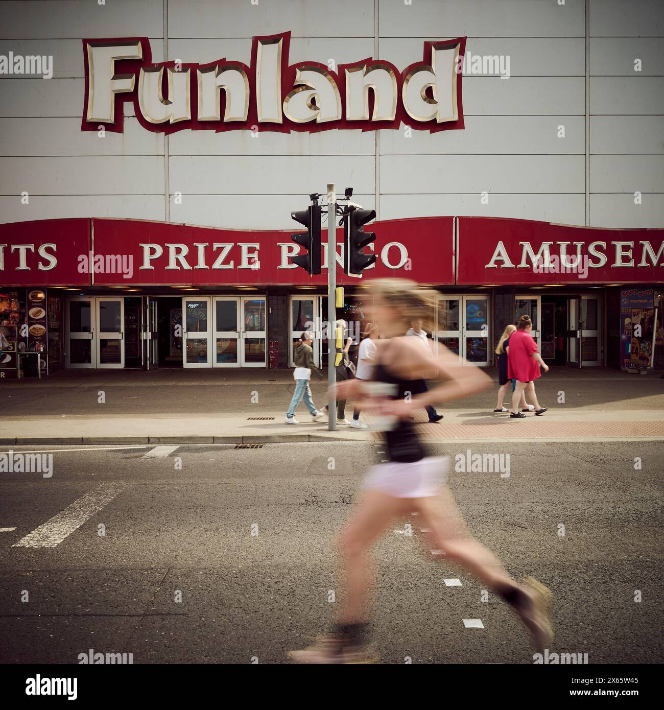 Female runner in the Blackpool 10K fun run passing Funland amusements ...