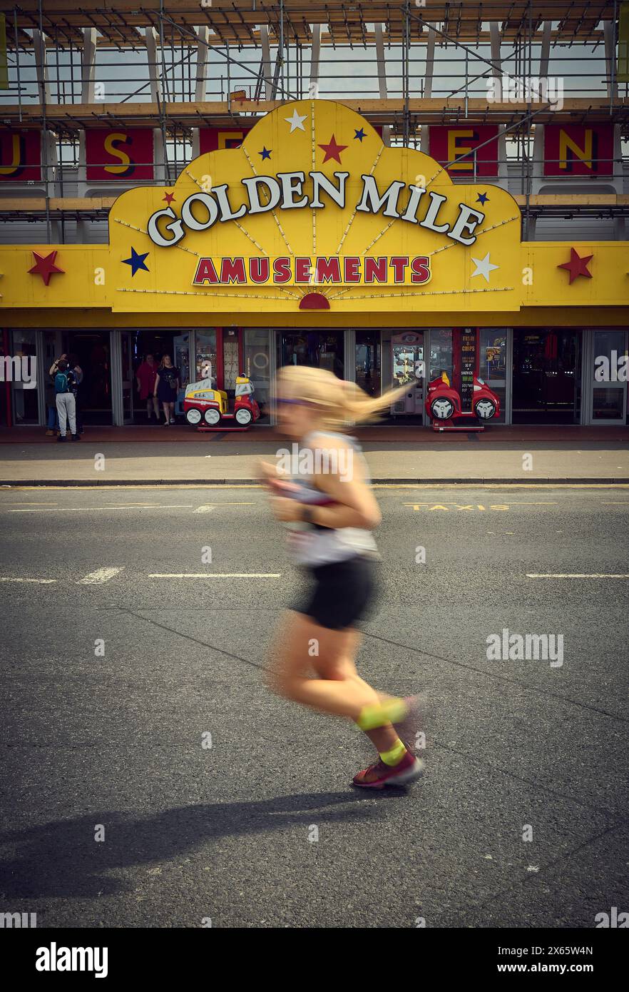 Female runner in the Blackpool 10K fun run passing Golden Mile ...