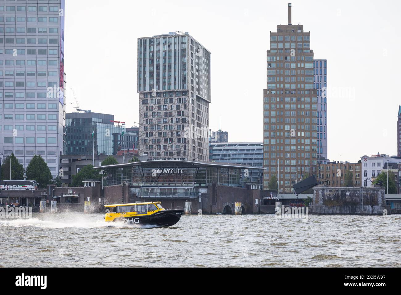 Water taxi sailing at the harbor of Rotterdam, public transport at the ...