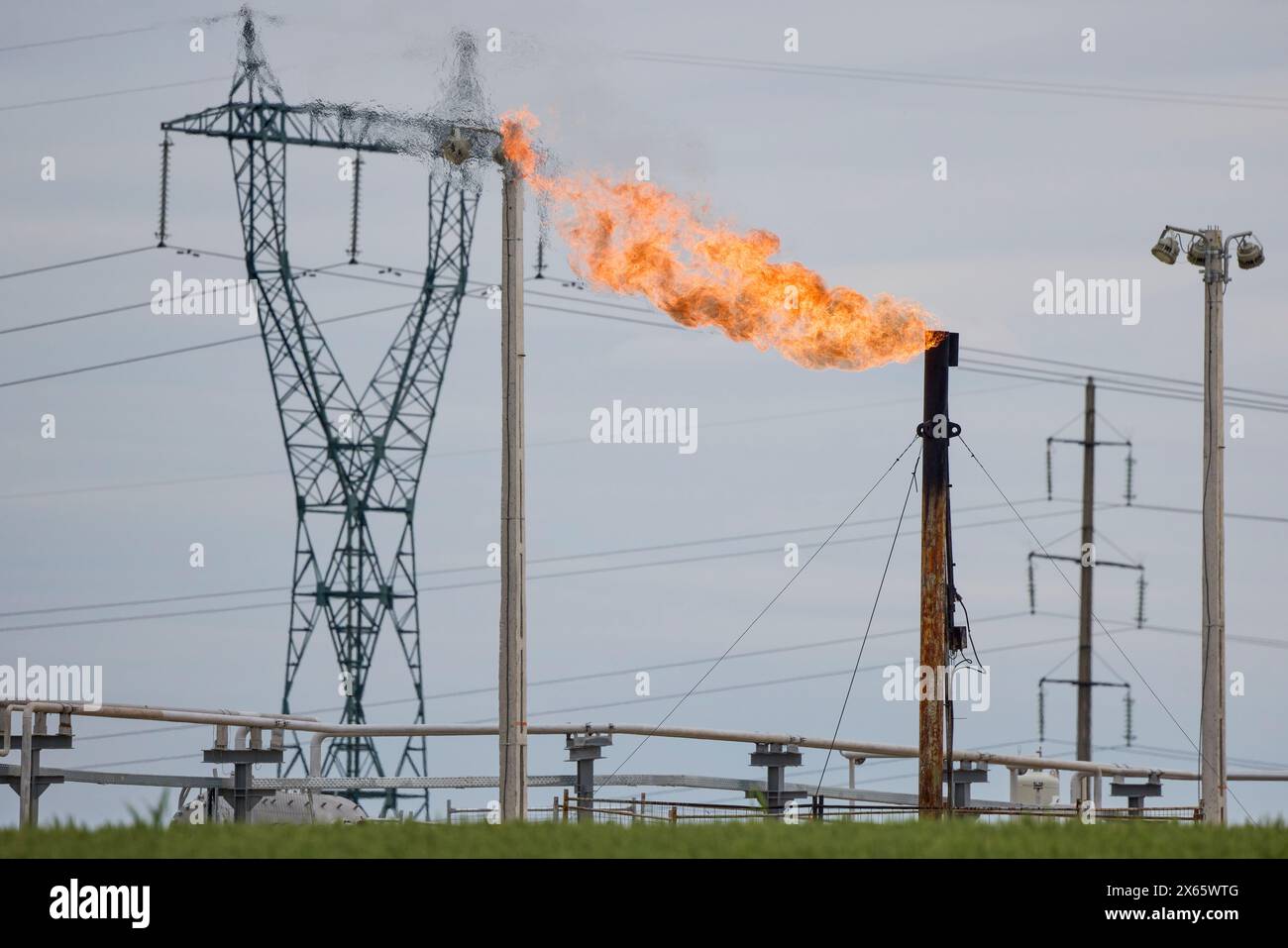 an oil rig with a large burning flame Stock Photo - Alamy