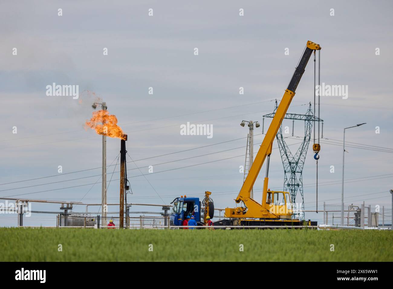 an oil rig with a large burning flame Stock Photo - Alamy