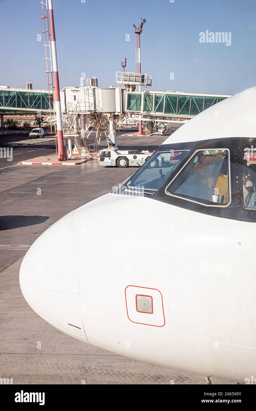 nose of modern jet aircraft in front of the airport terminal without ...