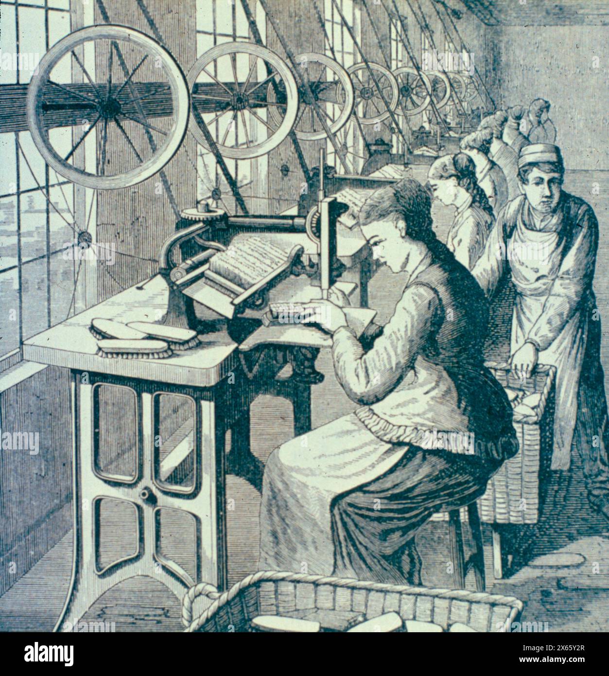 Women workers make brushes in a factory with steam-powered machines ...