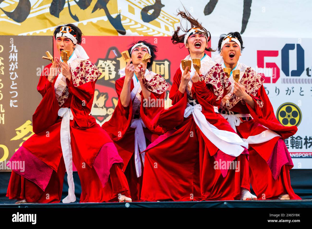 Group of four teenage yosakoi dancers on stage singing and holding ...