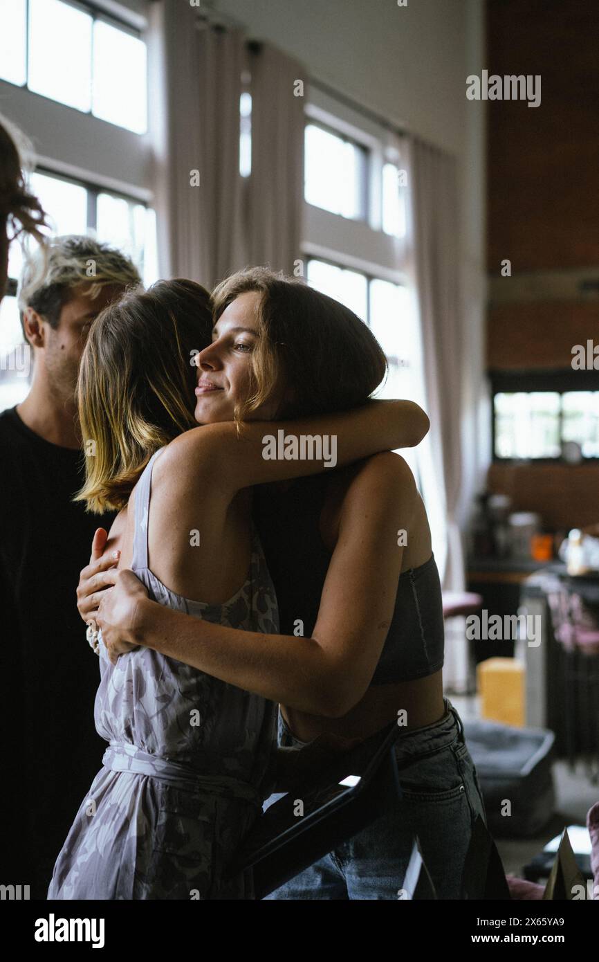 Friends hugging at a party Stock Photo - Alamy