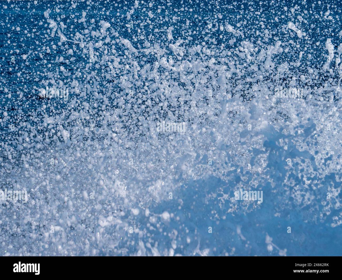 Sea spray generated by an outboard motor in Greenland. Beautiful water ...
