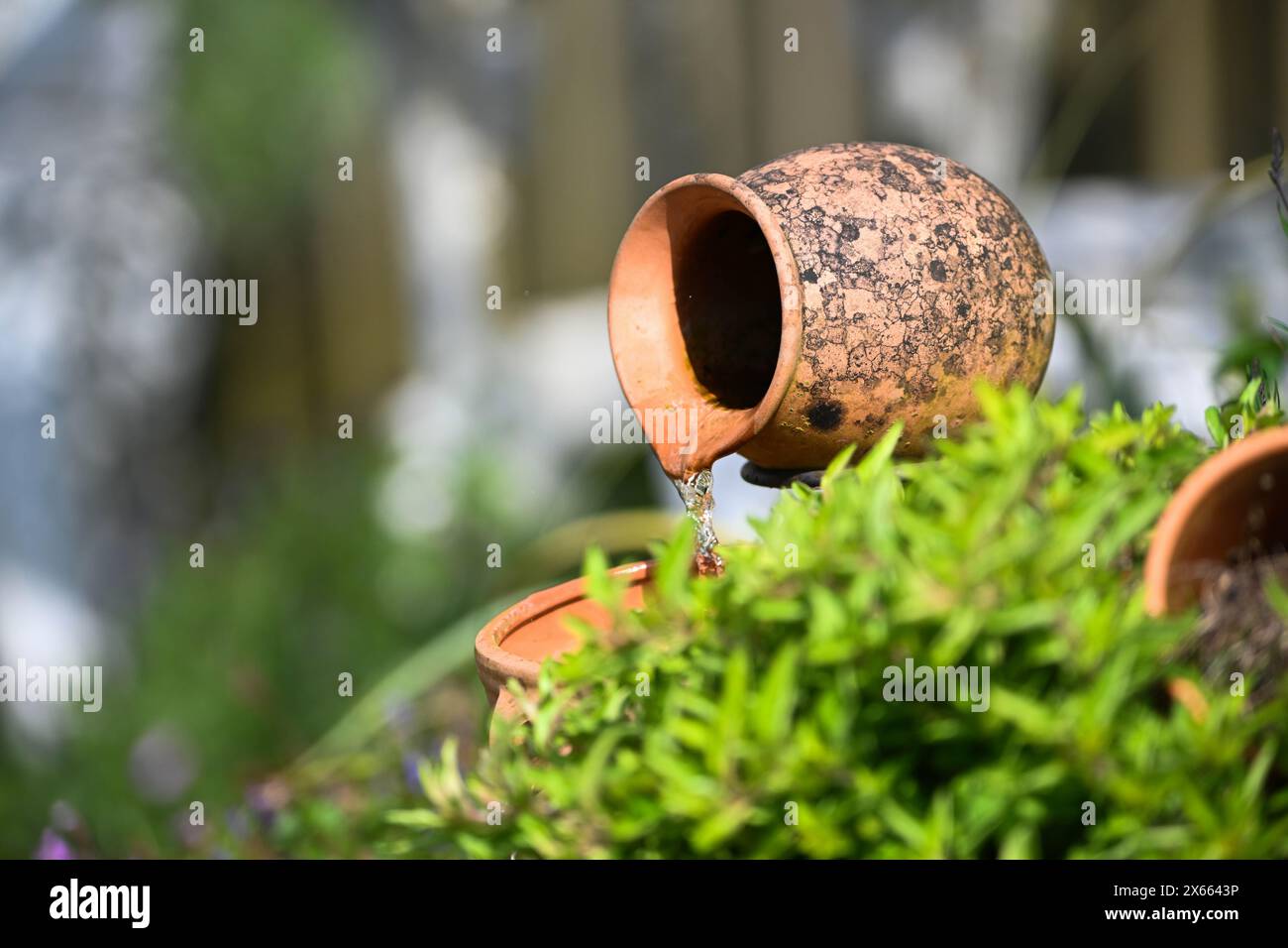 Pottery solar powered garden water feature UK Stock Photo - Alamy