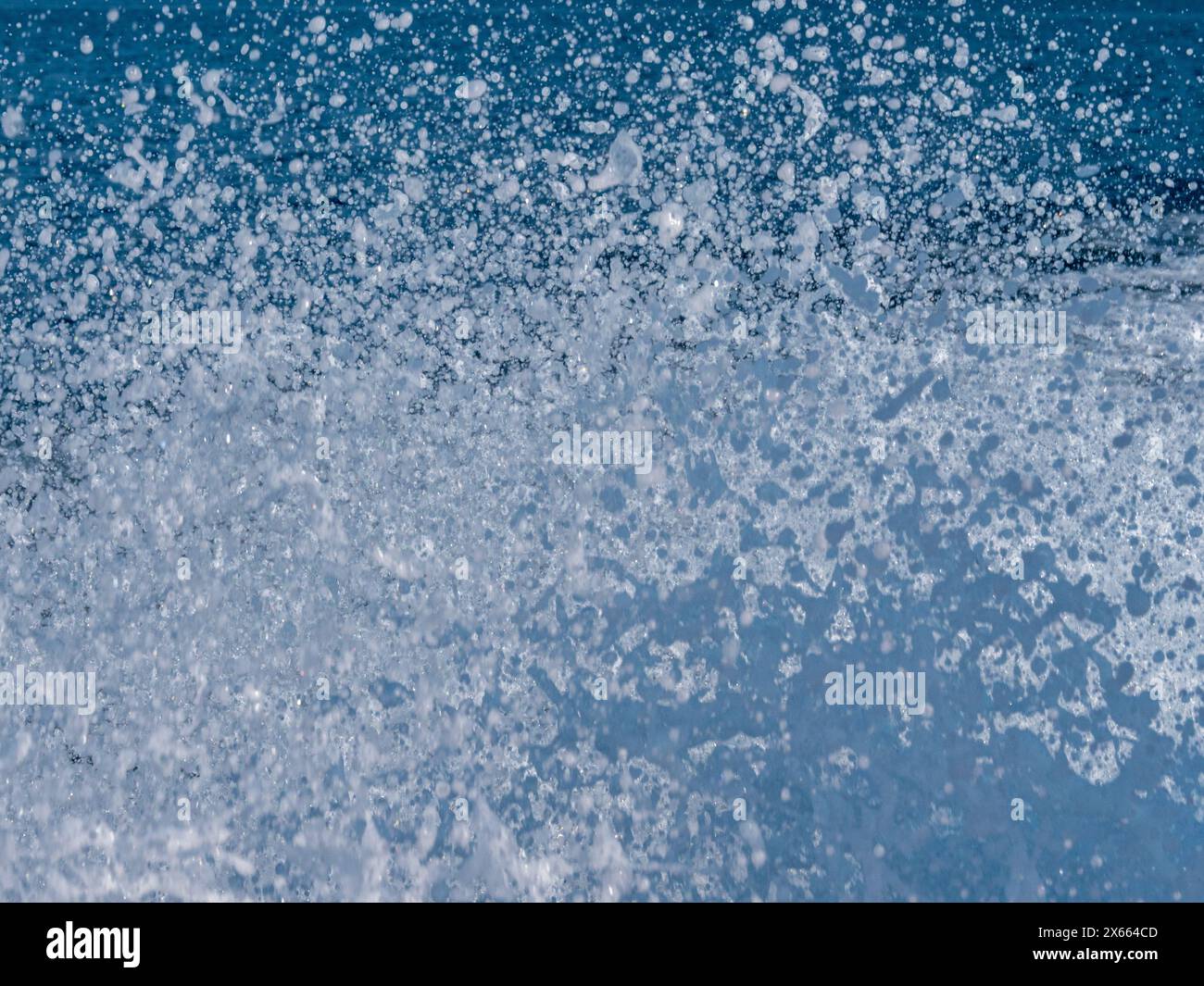 Sea spray generated by an outboard motor in Greenland. Beautiful water ...