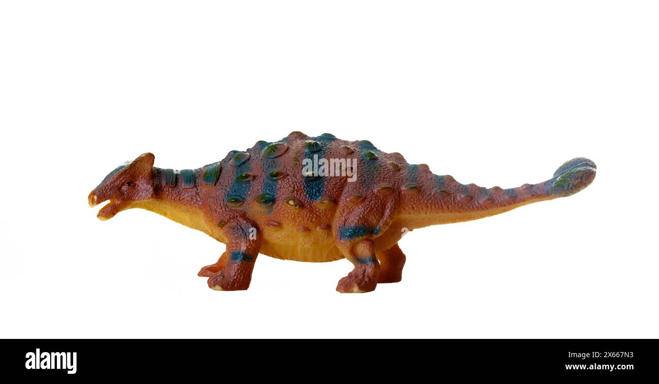 Detailed toy replica of a colorful ankylosaurus dinosaur isolated on a ...