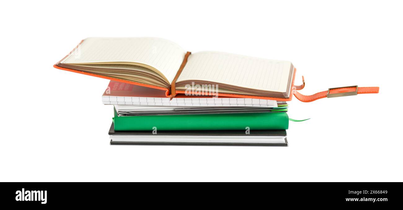 Opened blank notepad on a stack of closed notepads isolated on a white ...