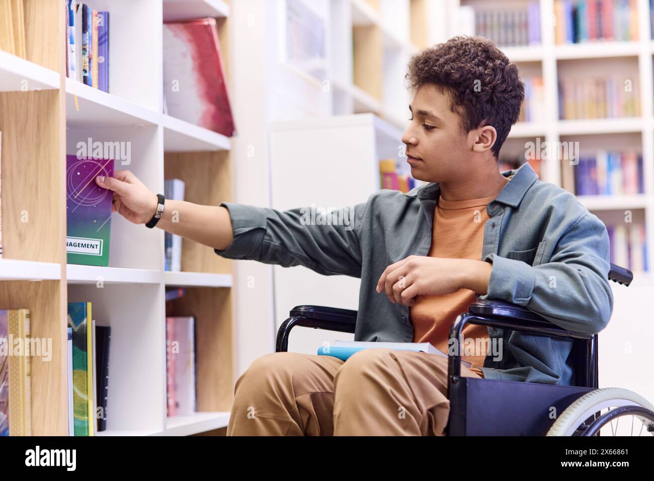 Side view portrait of young teenage boy with disability using ...