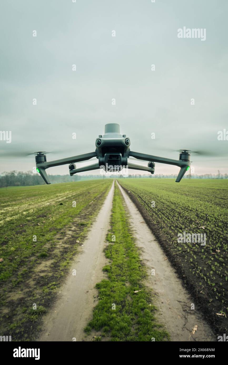 Aerial view of a drone moderning over farm fields, monitoring ...