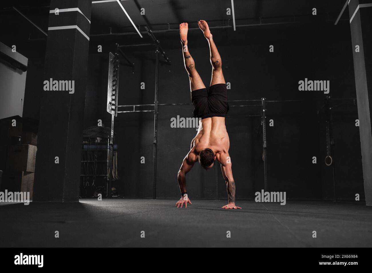 Rear view of handstand exercise, handstand push-ups. Routine workout ...