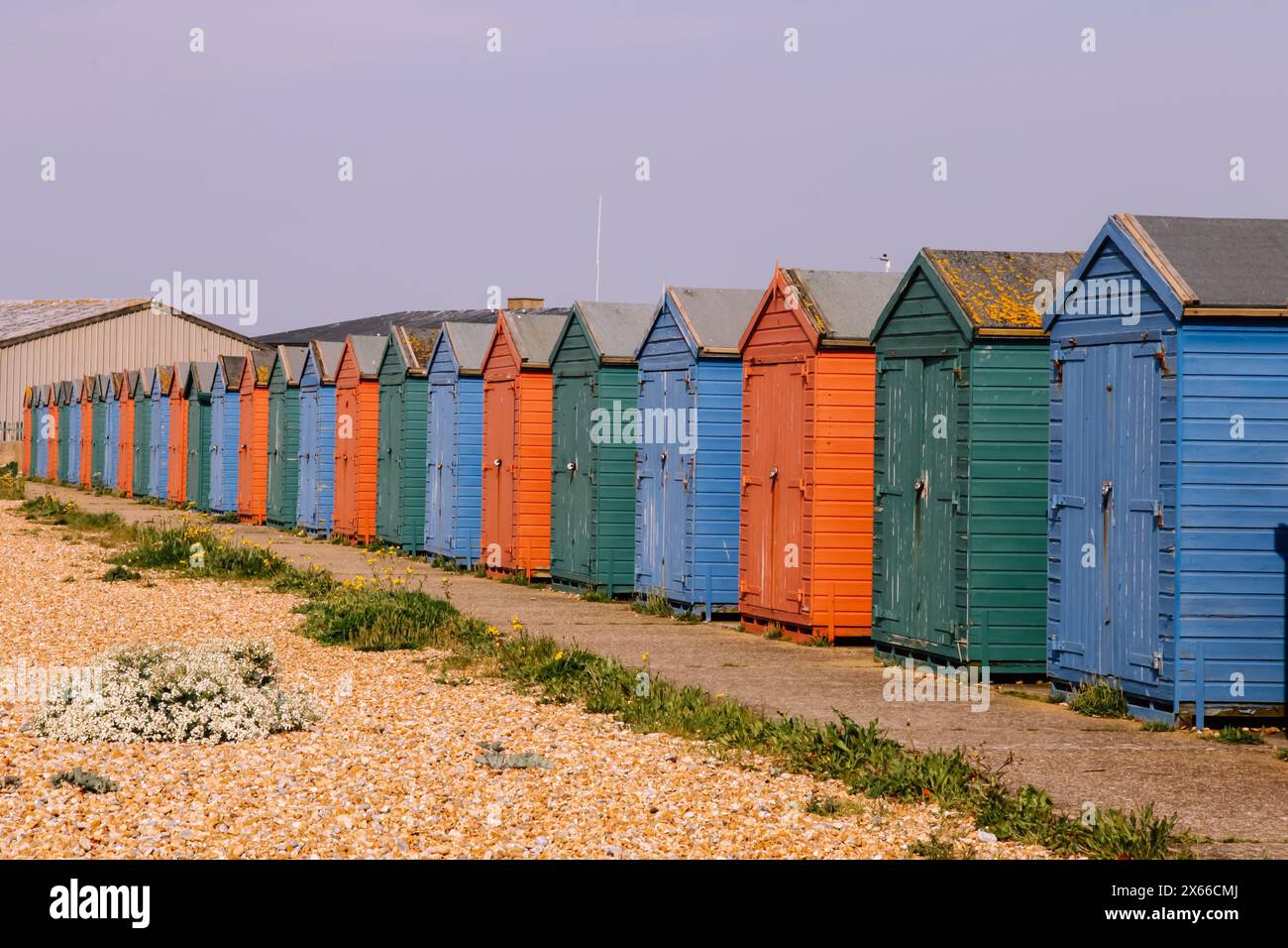 Colourful but aged beach huts lined up along St. Leonard on Sea beach ...