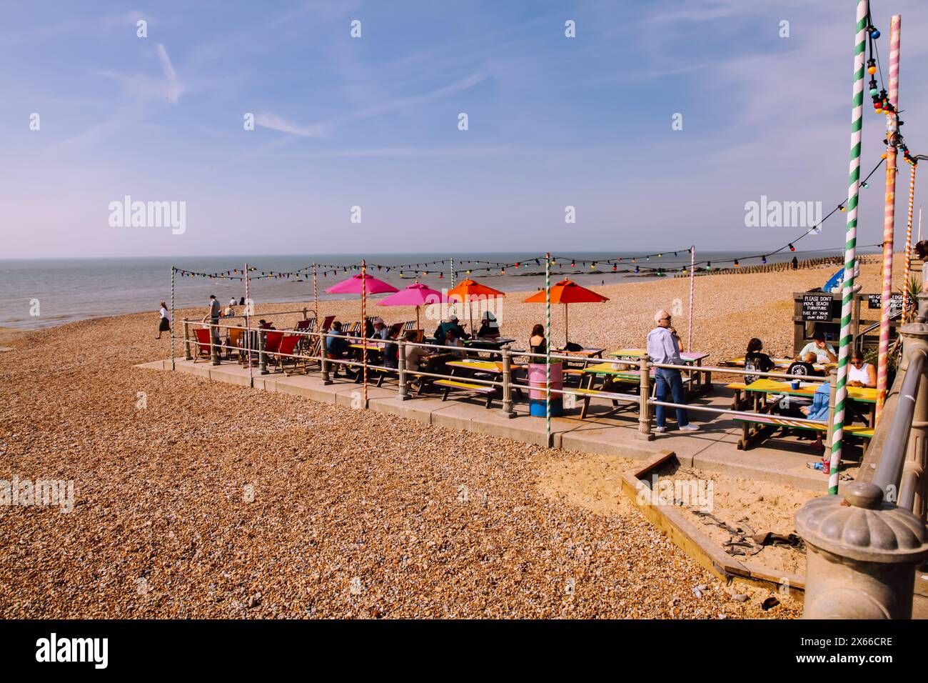 People eating outside on beach at Goat Ledge takeaway restaurant on ...