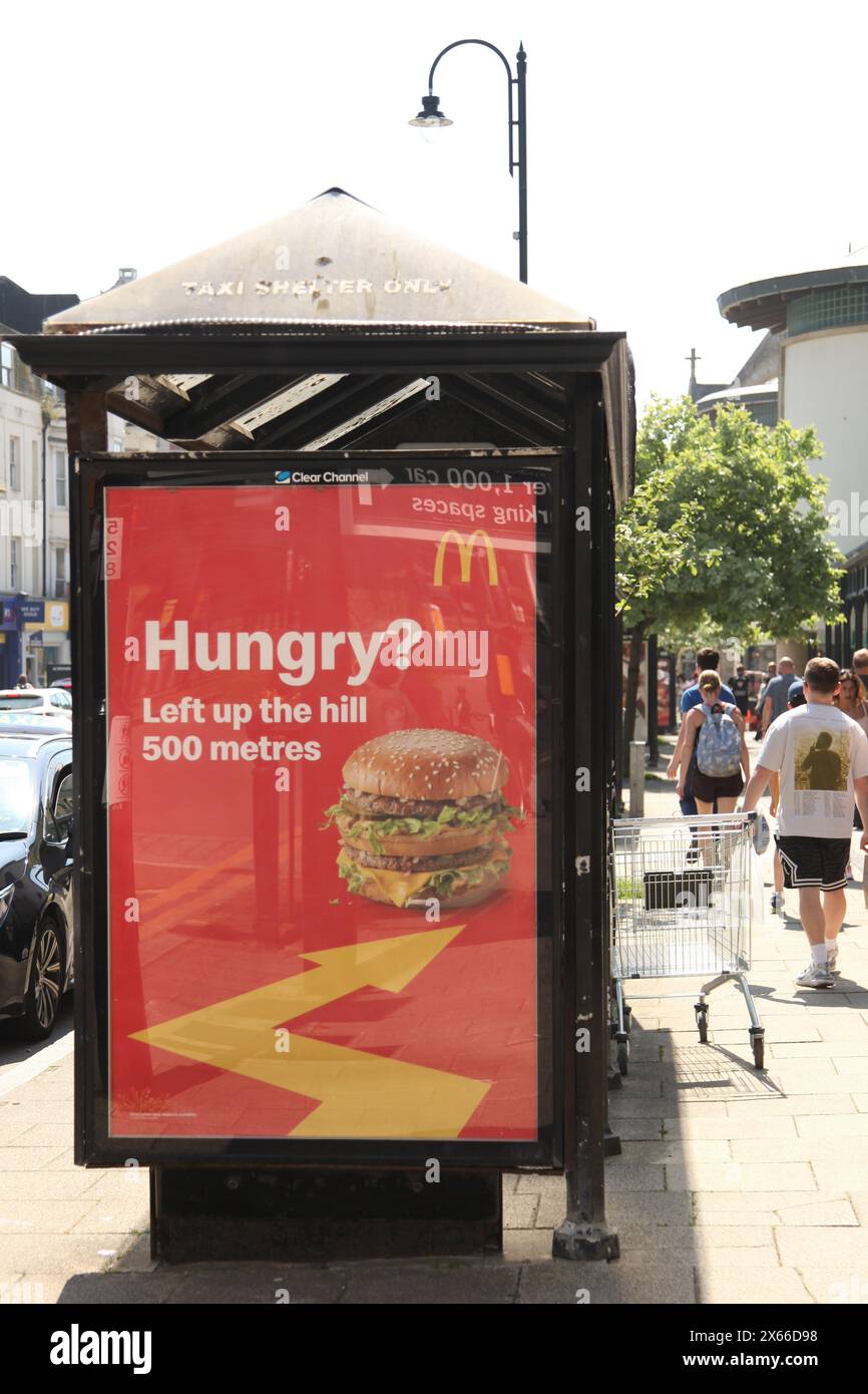 McDonalds fast junk food advert on bus stop advertising, Hastings, East ...